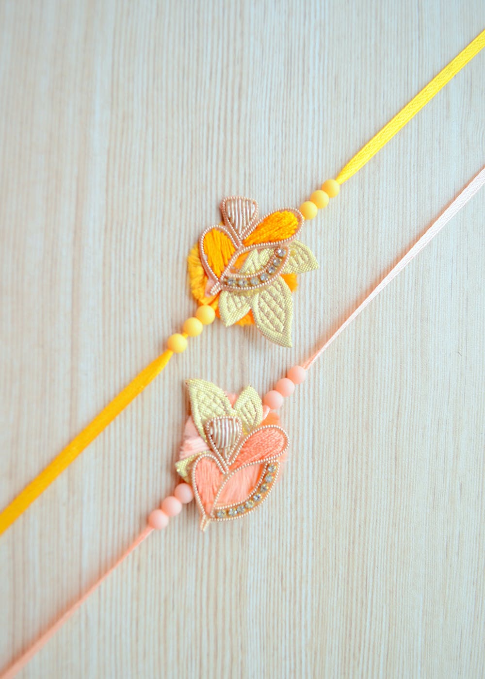 Get Yellow, Peach And White Artisanal Leaf Rakhi - Set of 2 at ₹ 419 ...