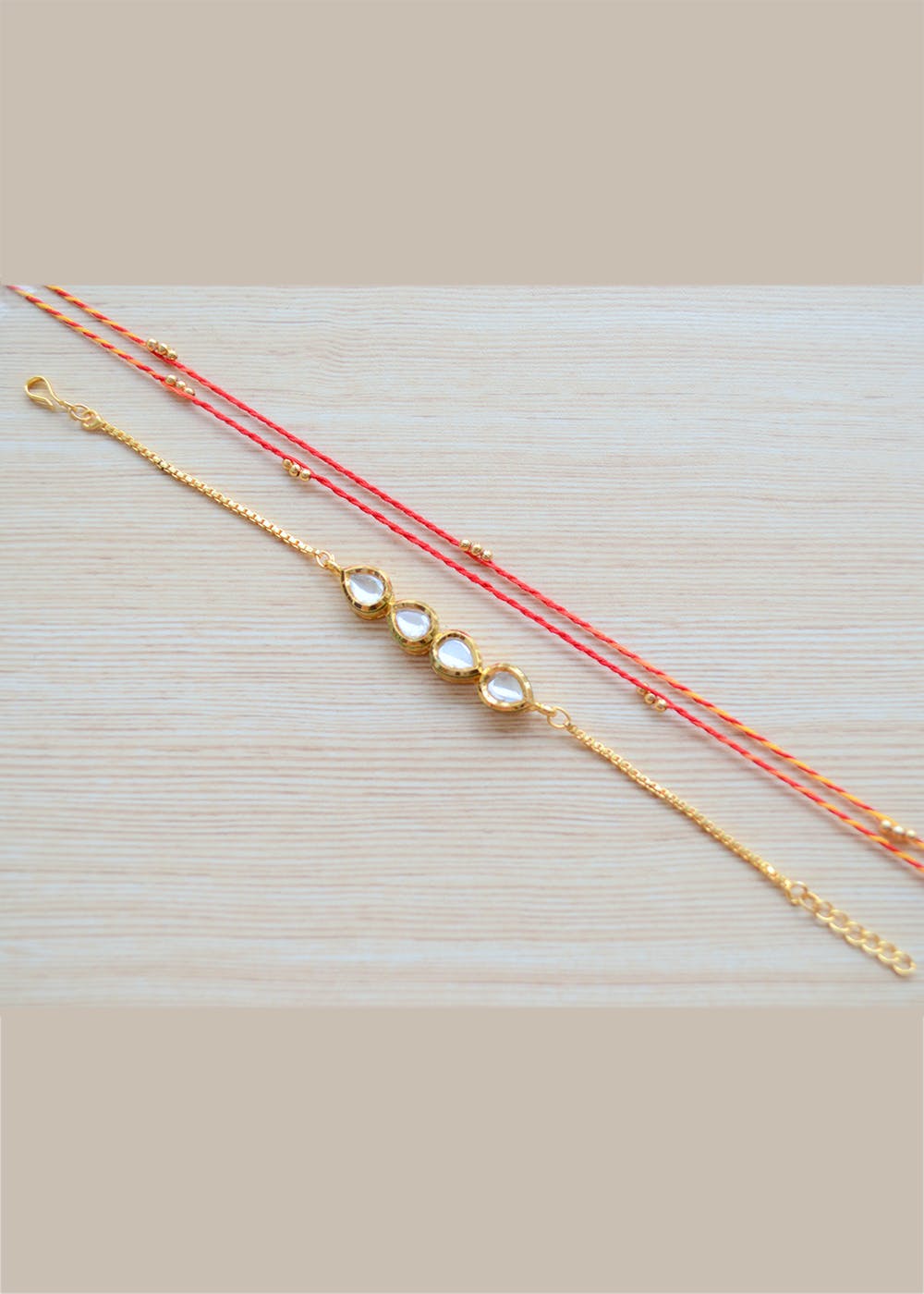Get Sacred Mauli Thread Rakhi with Drop Shaped Faux Polki Bracelet Gift ...